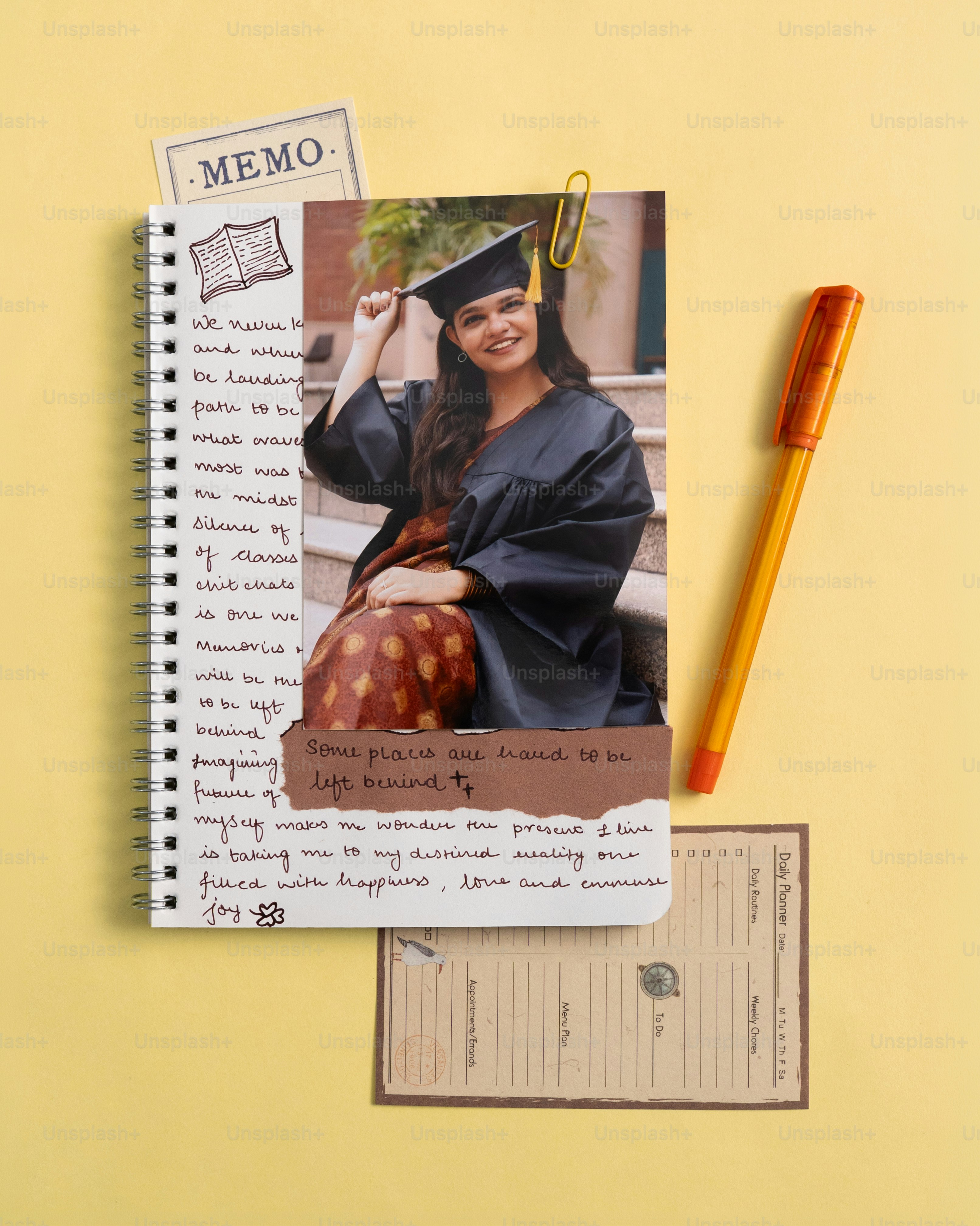 Open journal displaying handwritten notes, photos, and pen. photo ...