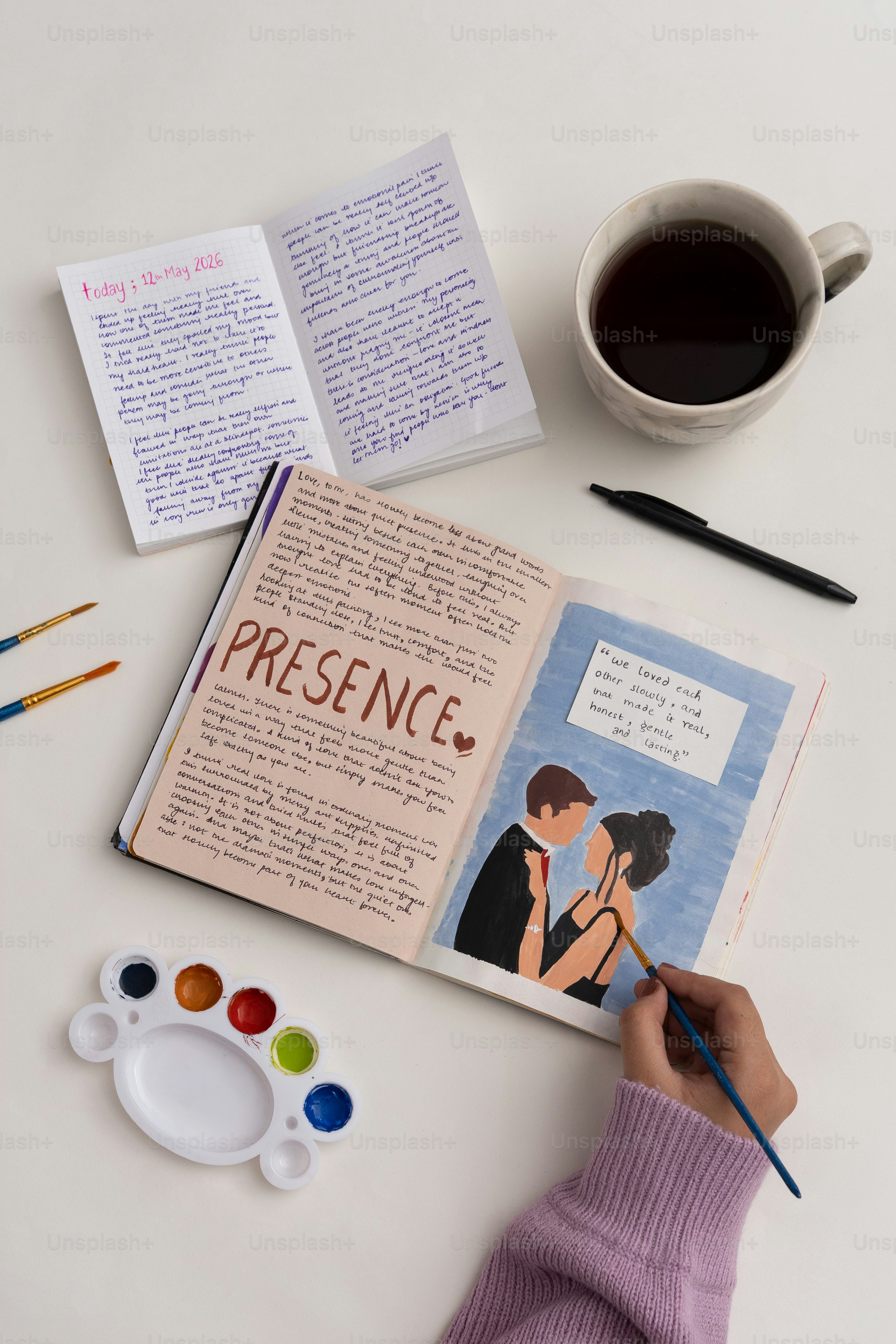 Hand coloring a journal with crayons and other art supplies. photo ...