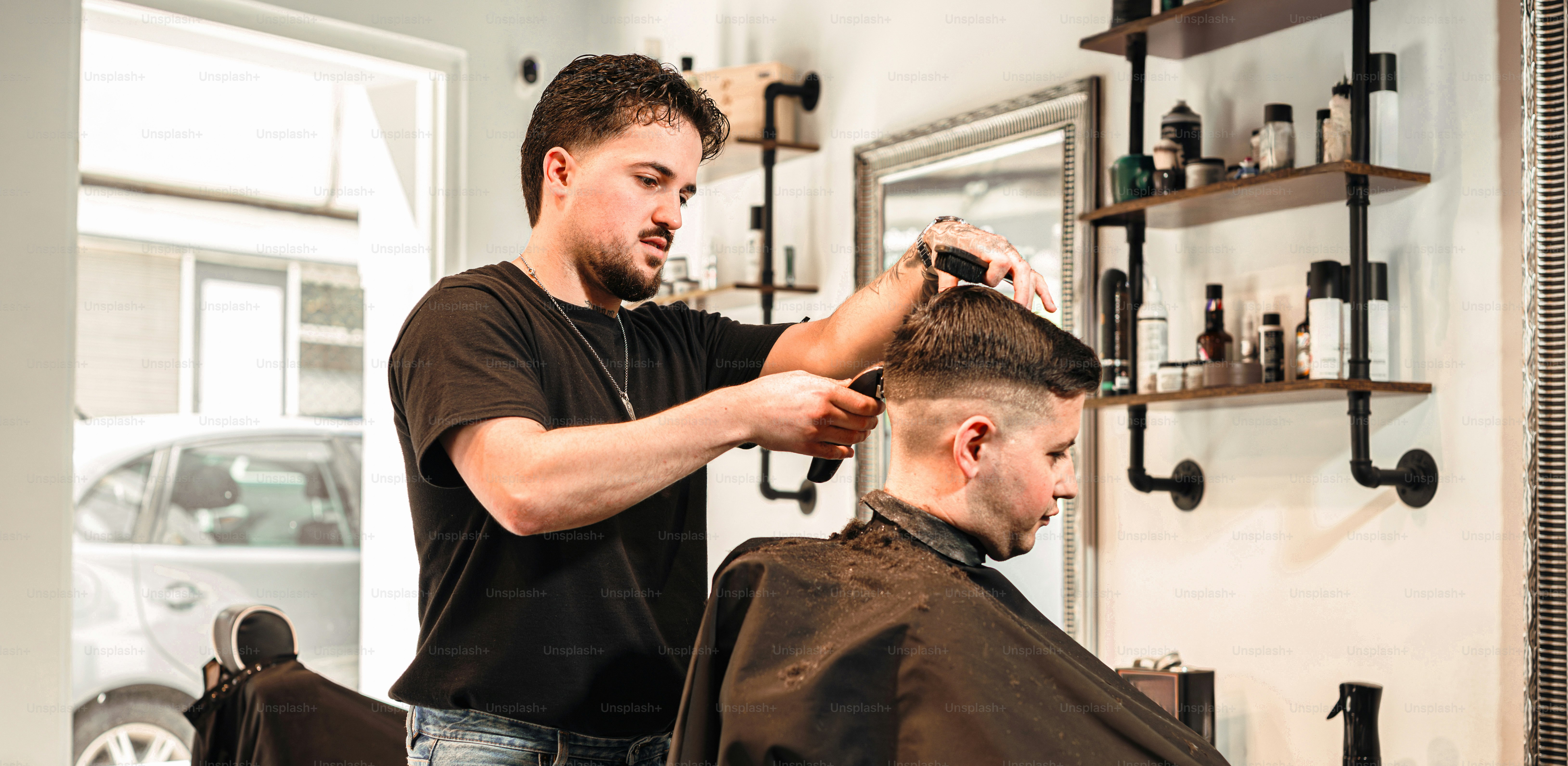 Professional barber cutting a man's hair in a barbershop. photo ...