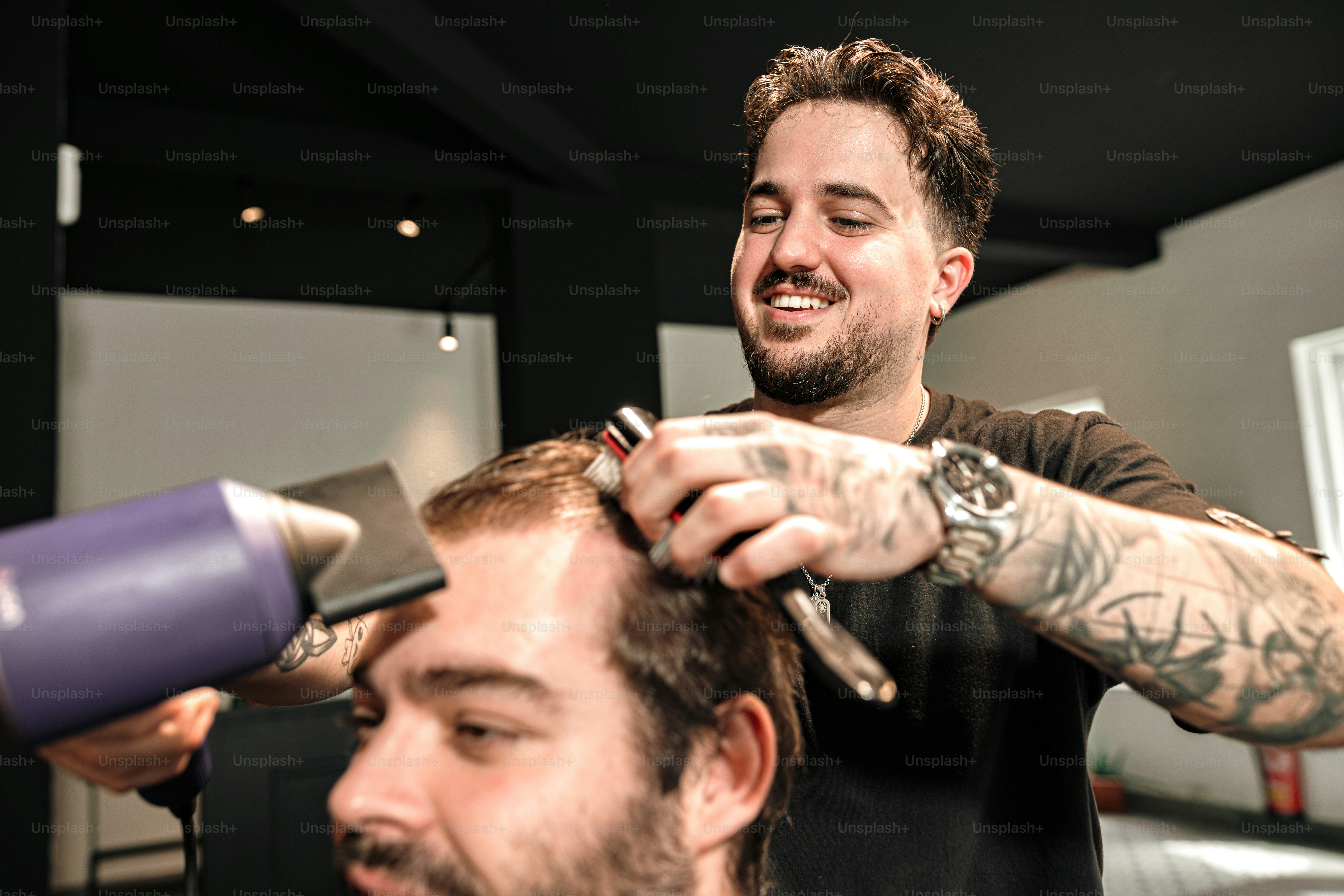 Professional barber cutting a man's hair in a barbershop. photo ...