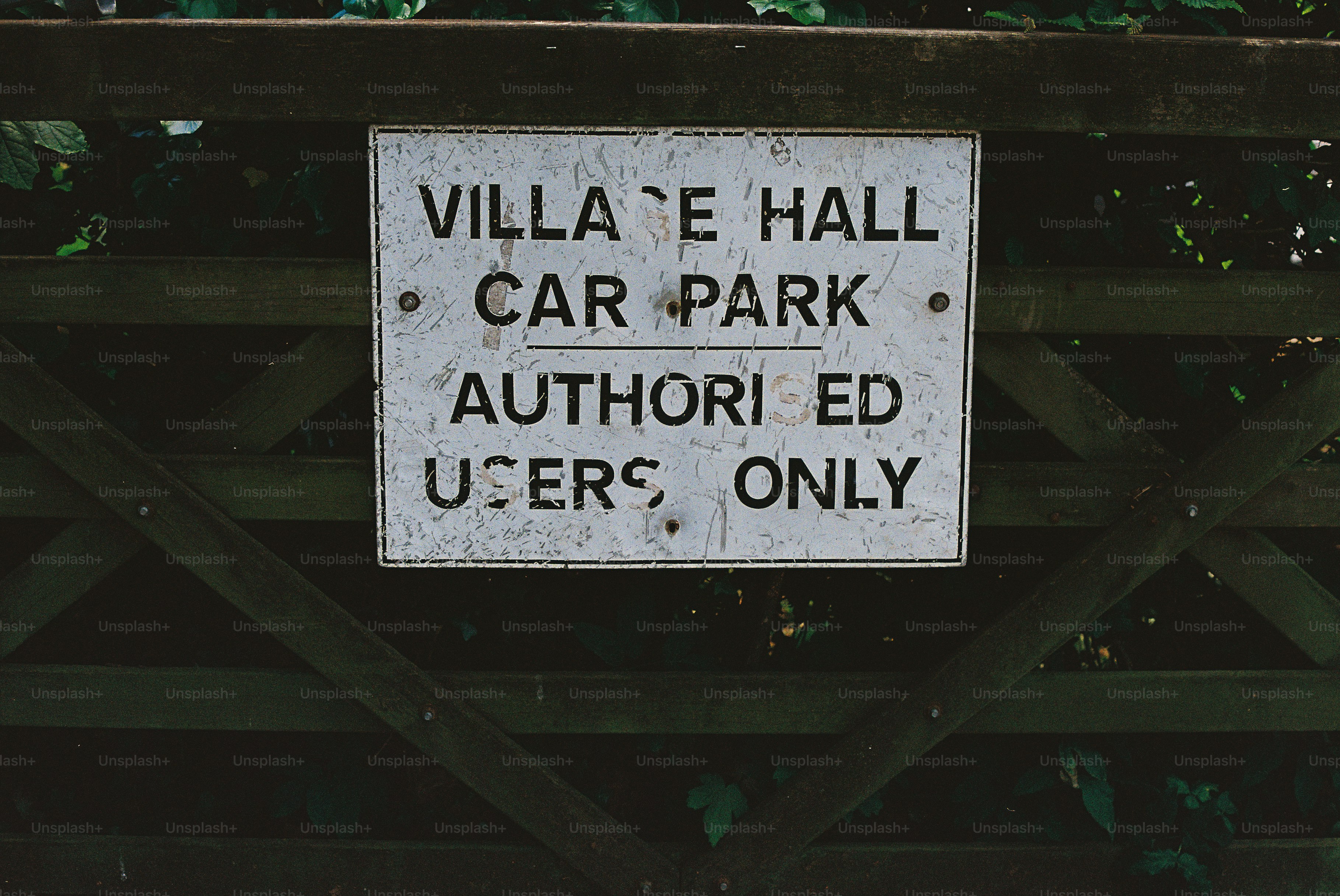 Village hall car park sign on a dark wooden fence. photo – Signage ...