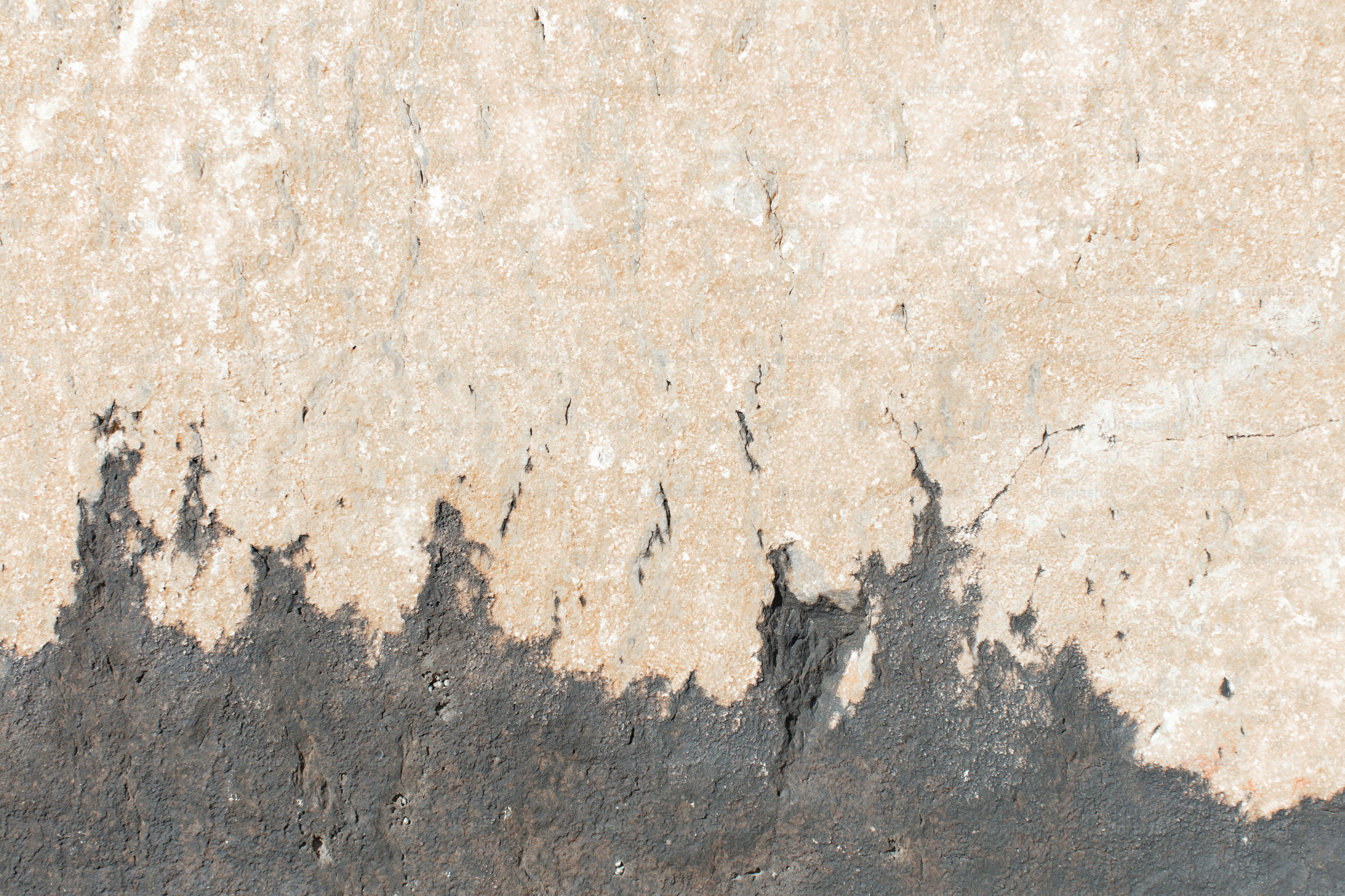 Weathered concrete wall with distinct light and dark textures. photo ...