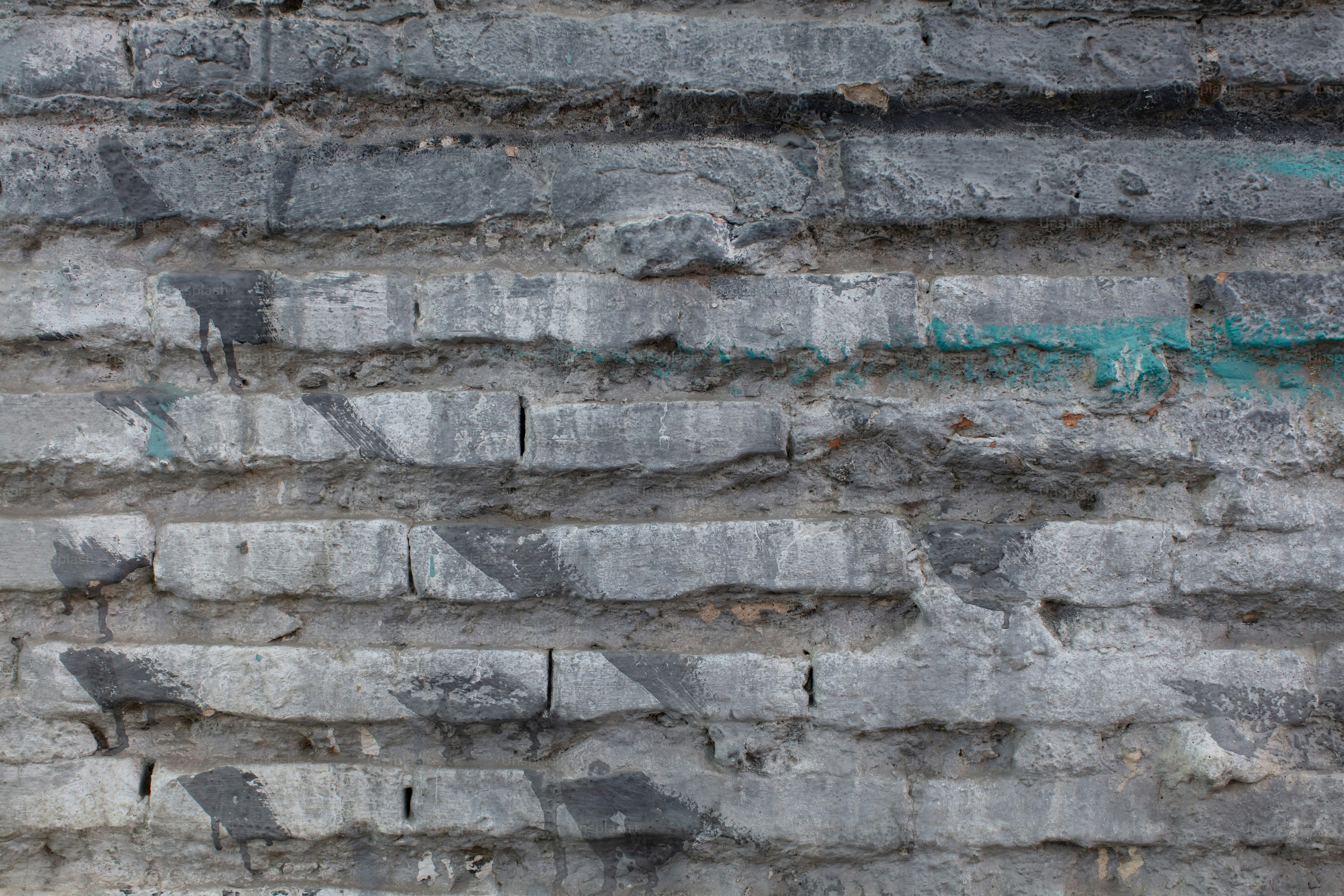 Rough, grey concrete wall with horizontal grooves and green marks ...