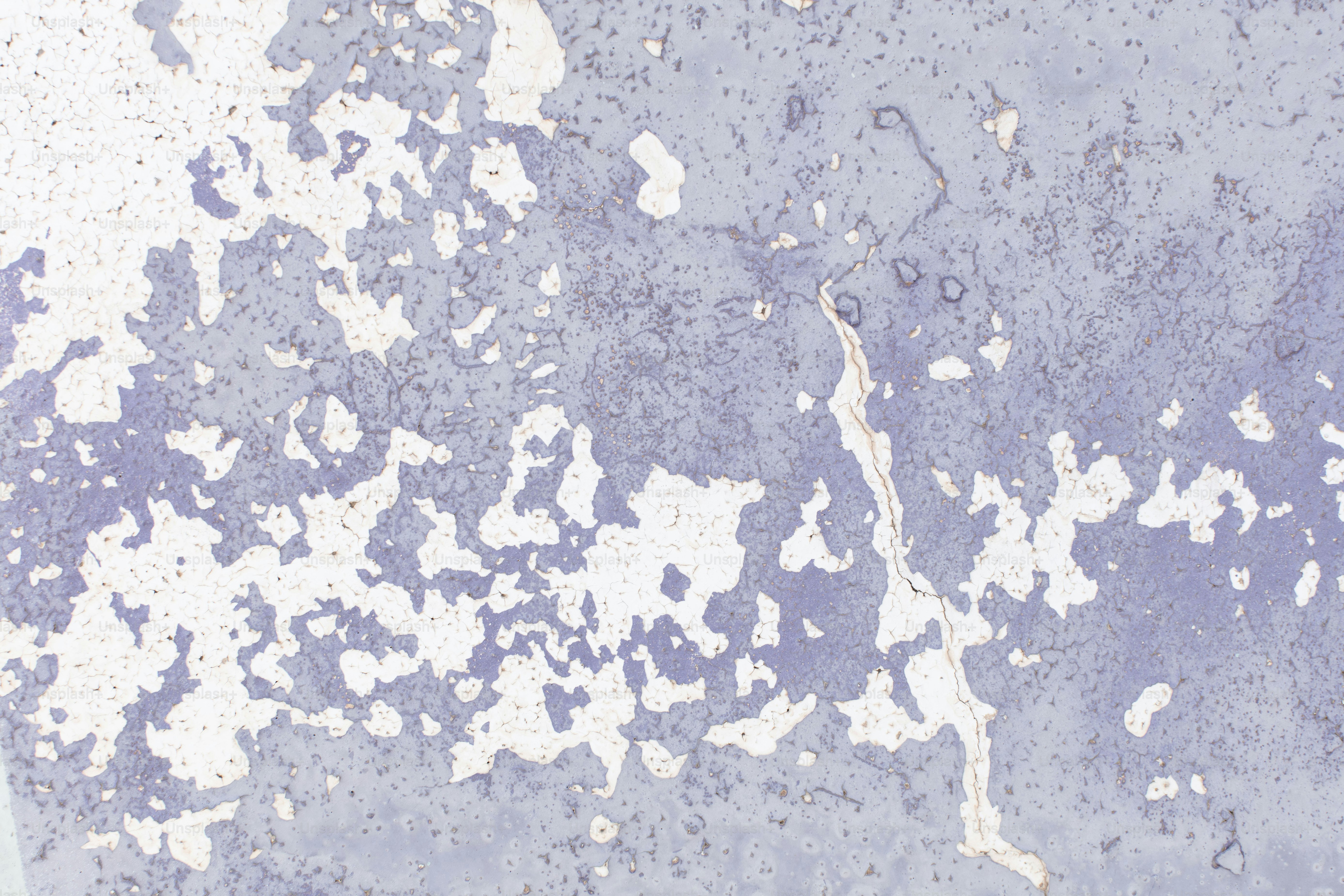 Abstract texture of peeling purple paint on a white surface. photo ...