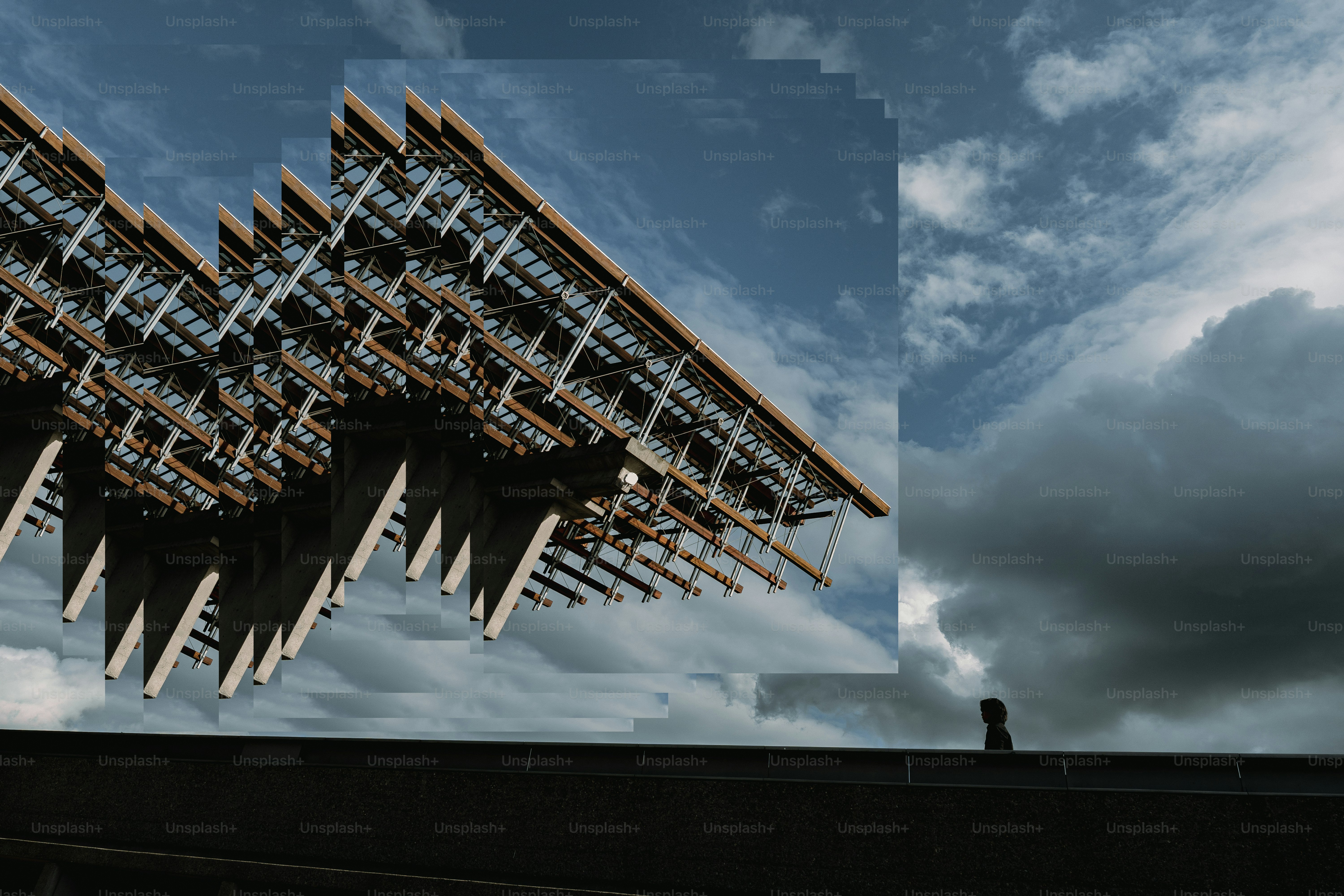 Person on a ledge beneath a fragmented, cloudy sky. photo – Abstract ...