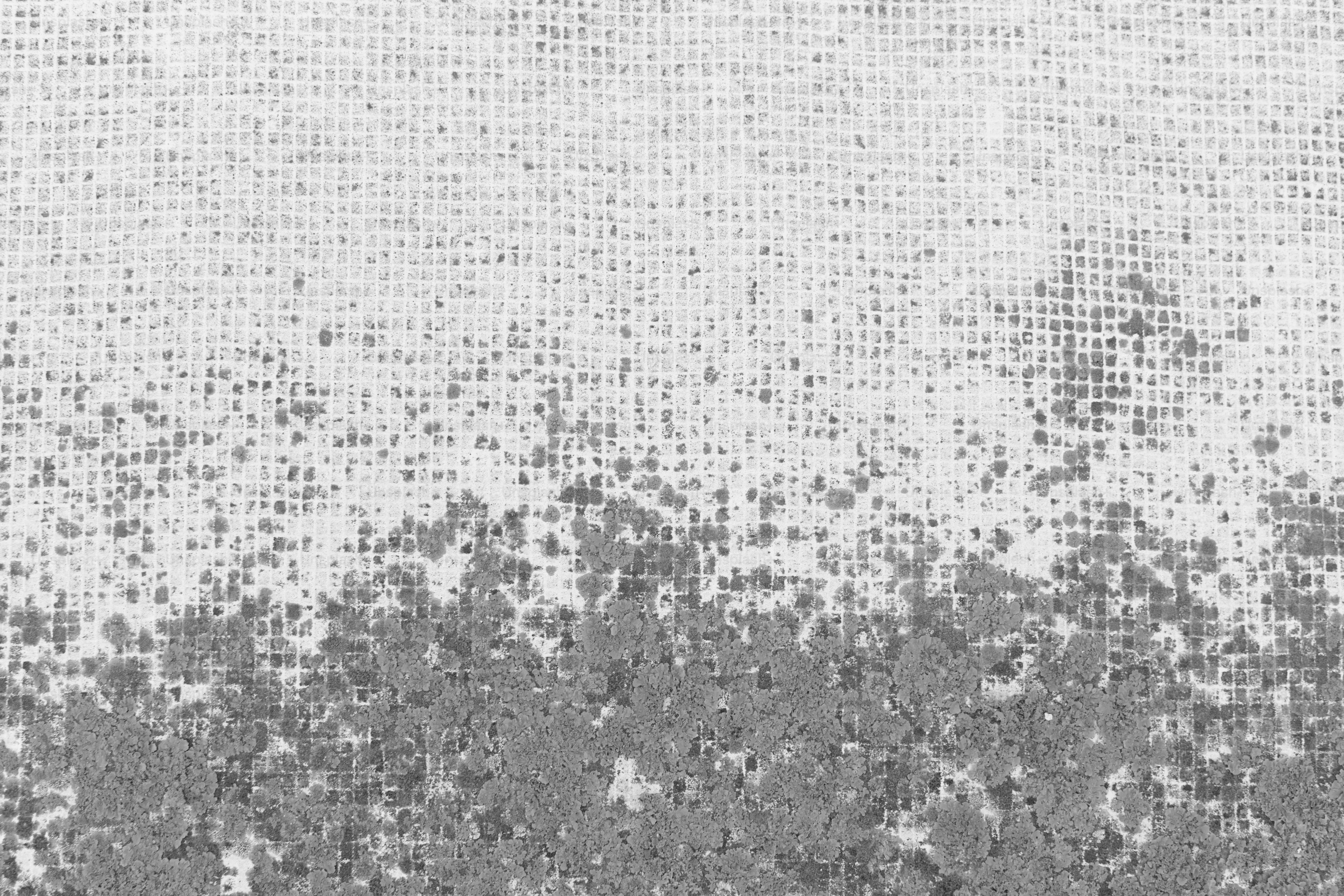 Textured white surface with an irregular brown stain and holes. photo ...