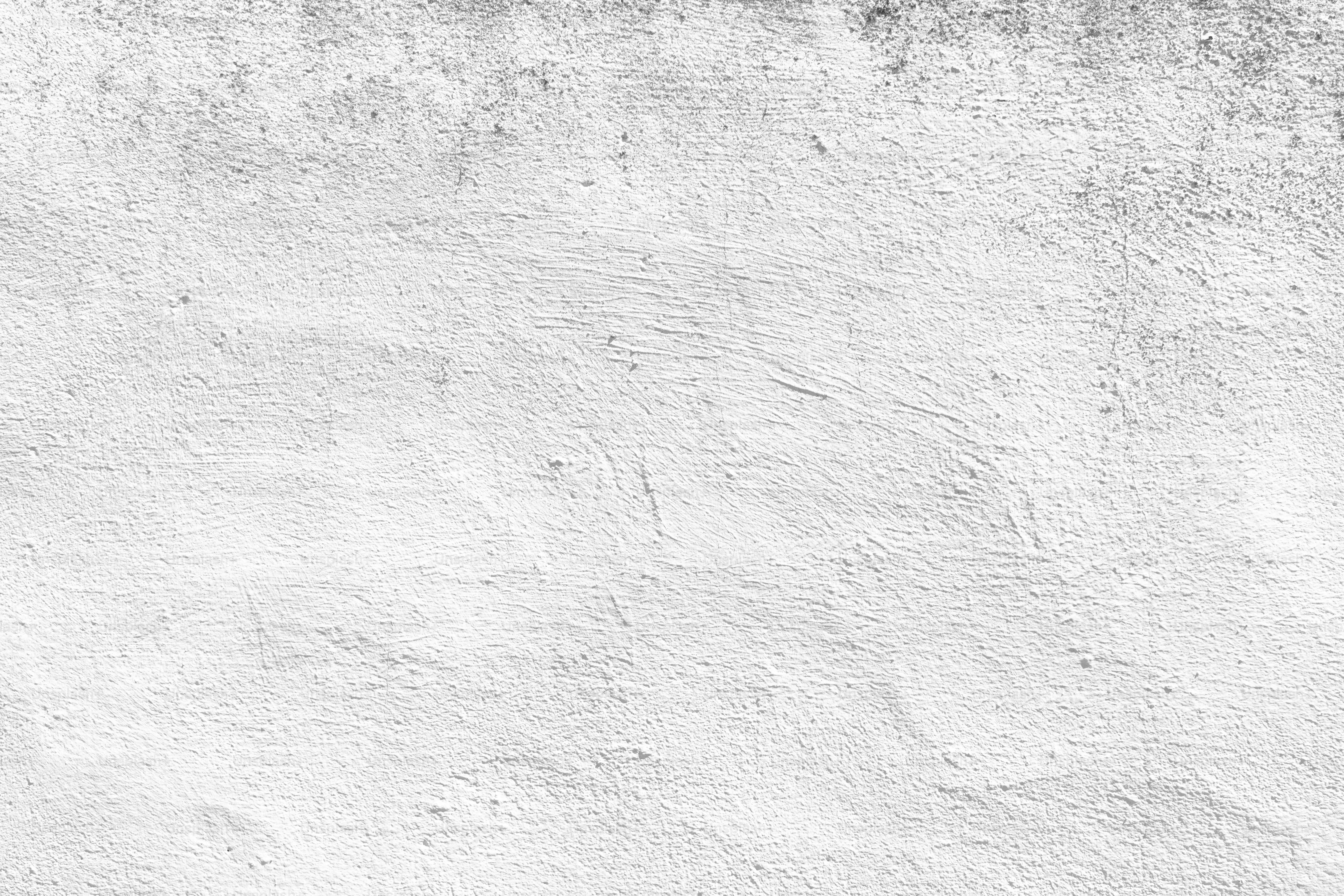 Textured white surface with an irregular brown stain and holes. photo ...
