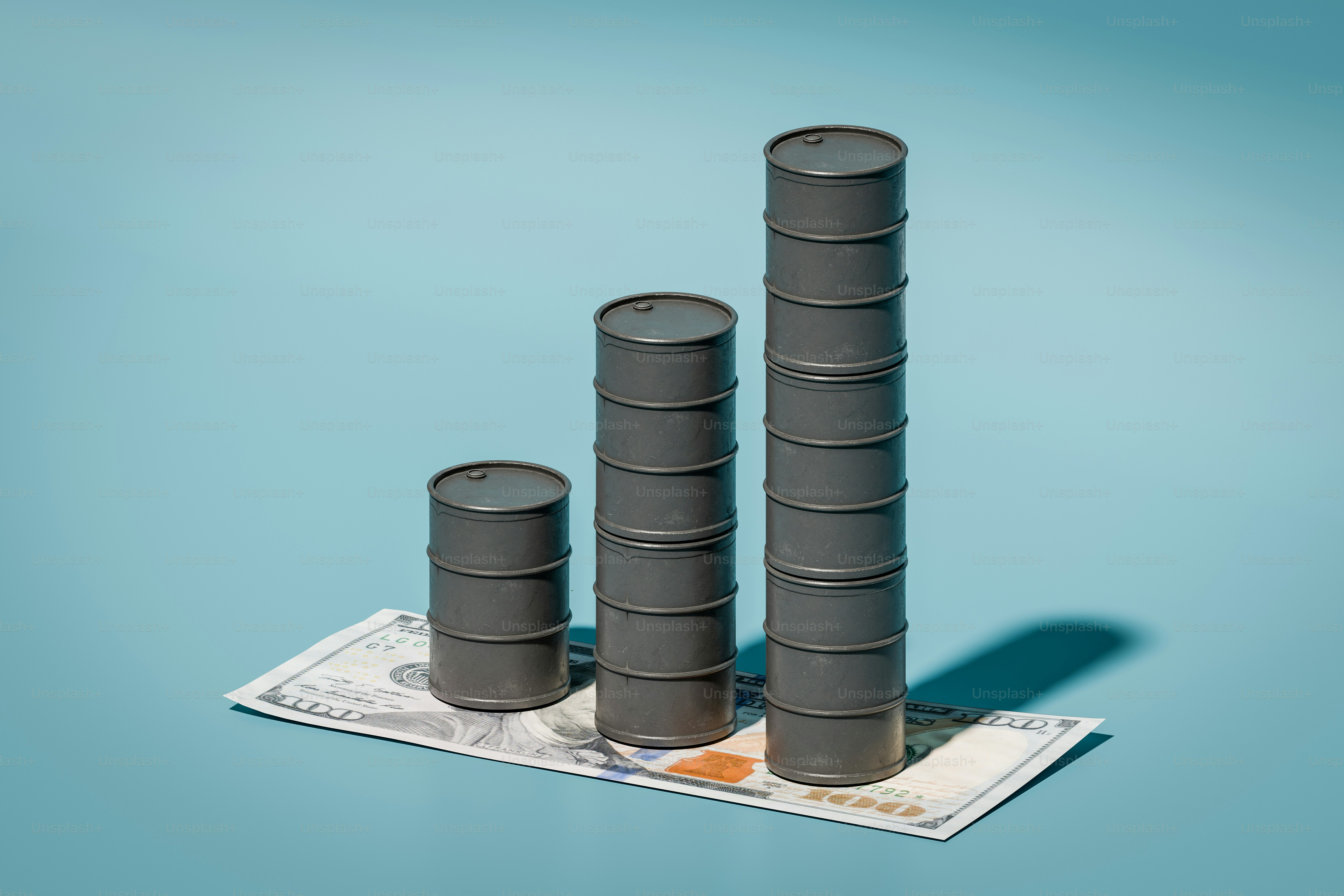 Oil barrels forming a rising graph on a dollar bill. photo – Money ...