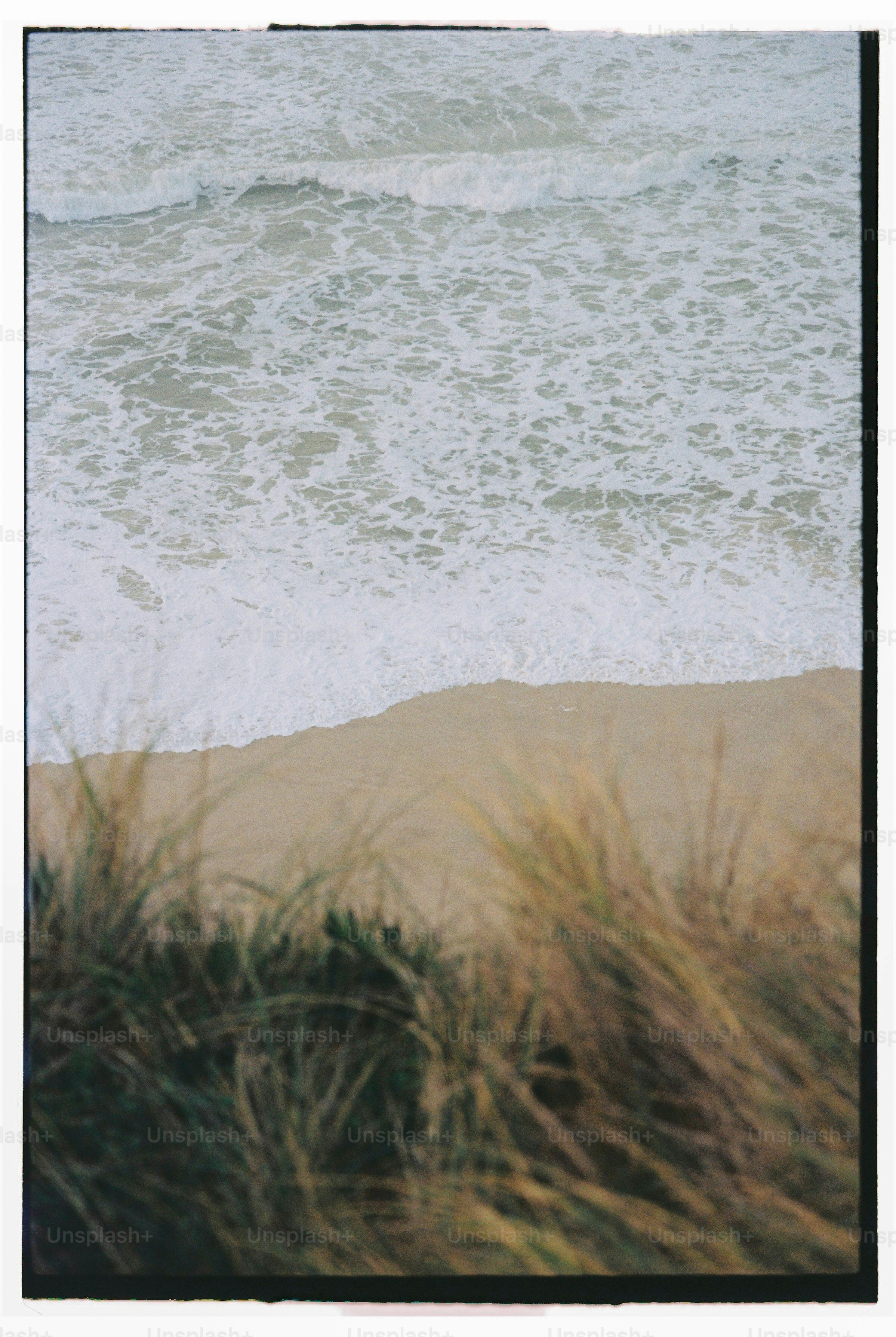 Sandy beach with rocky cliffs and turquoise ocean water. photo ...