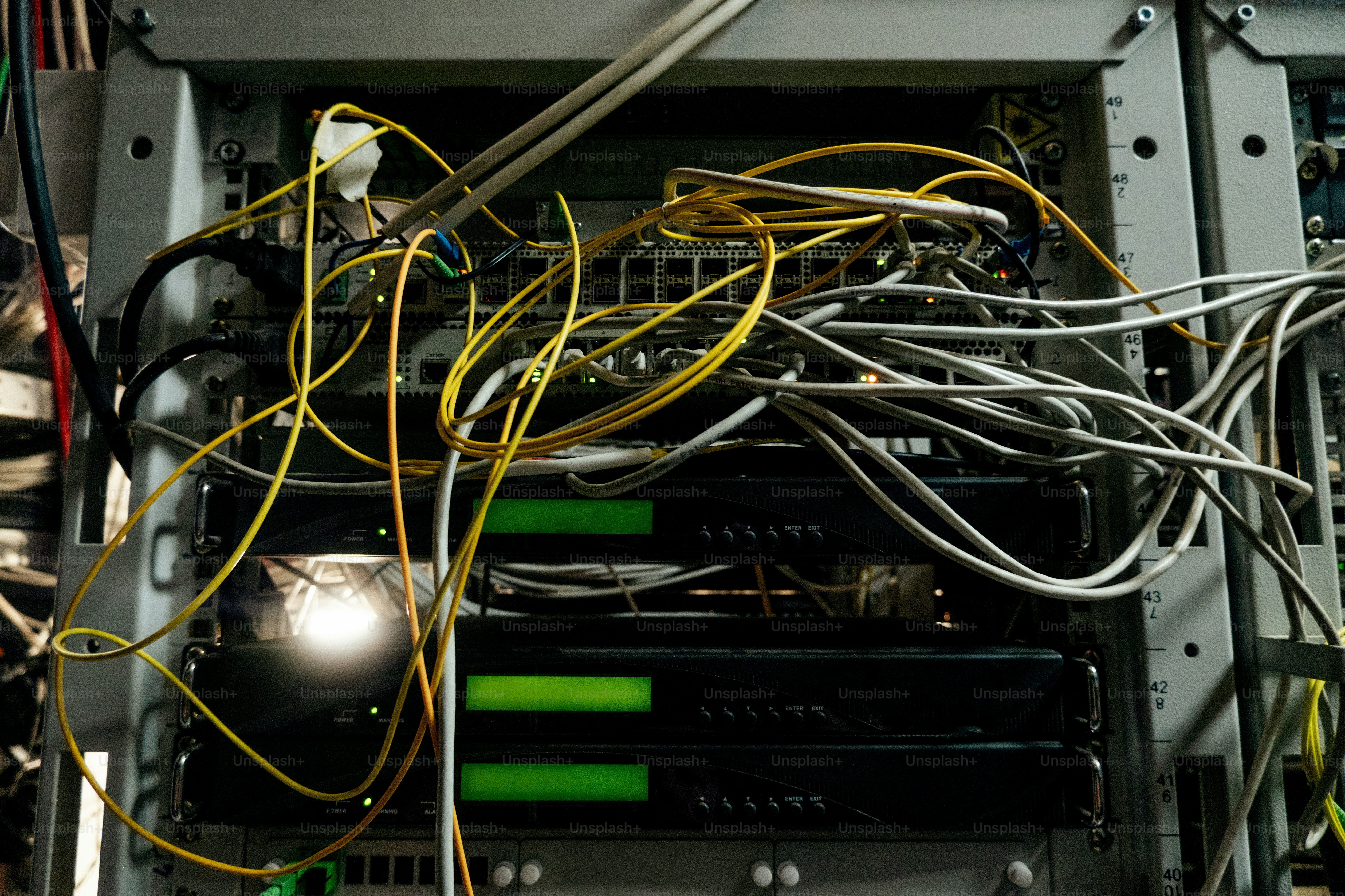 Multiple servers in a data center rack photo – Technology Image on Unsplash